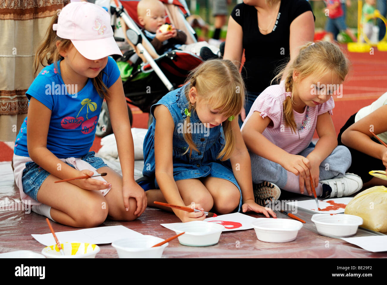 Children are having fun painting pictures Stock Photo - Alamy
