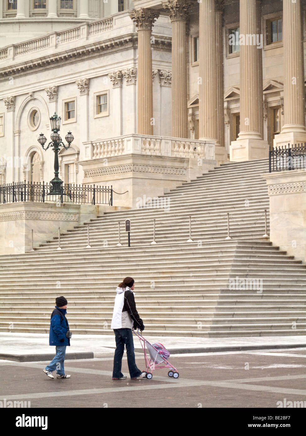 Mother and son walking past U.S. Capitol steps. Inauguration Eve ...