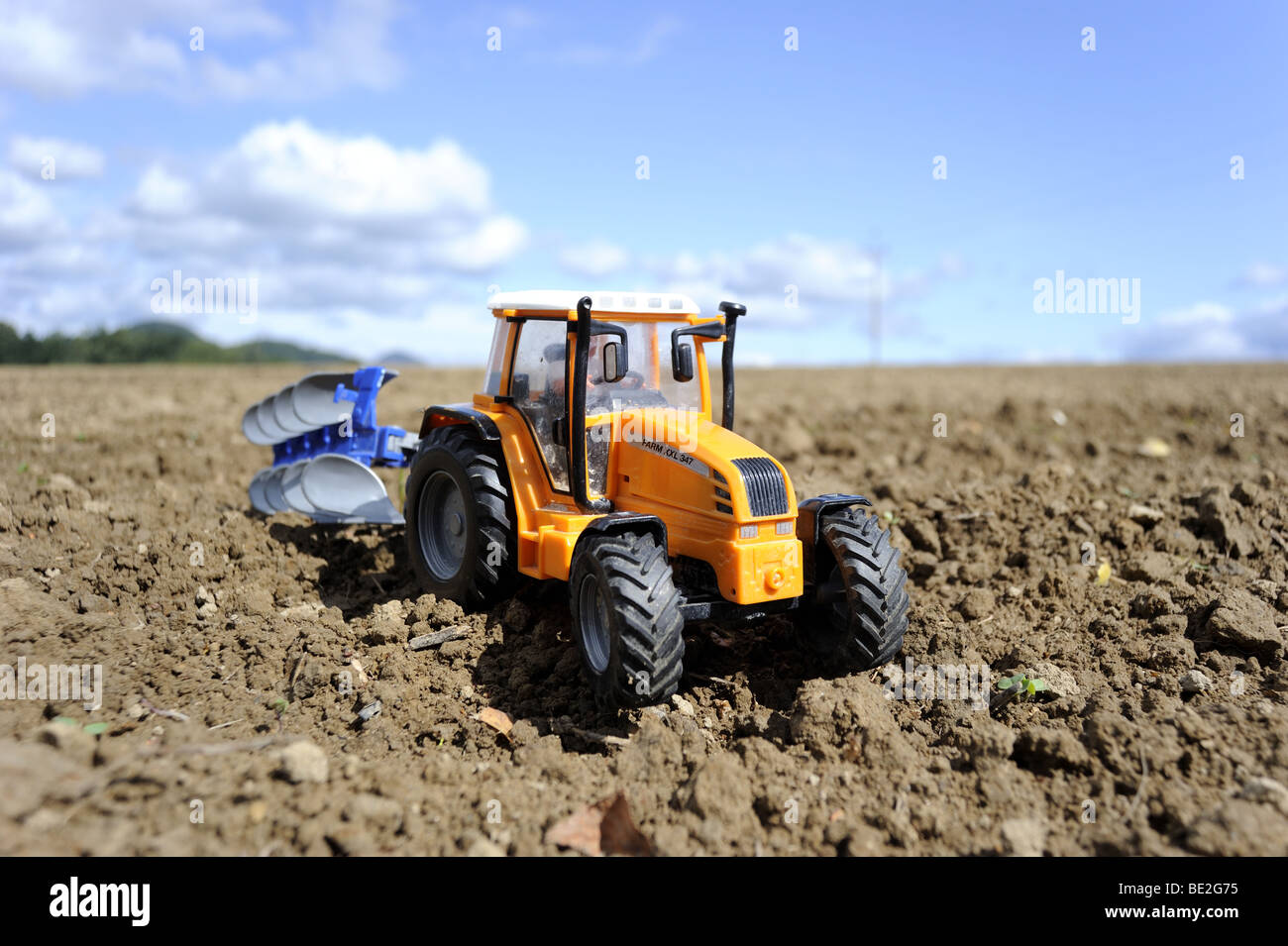 Plastic Toy Tractor on field Stock Photo - Alamy