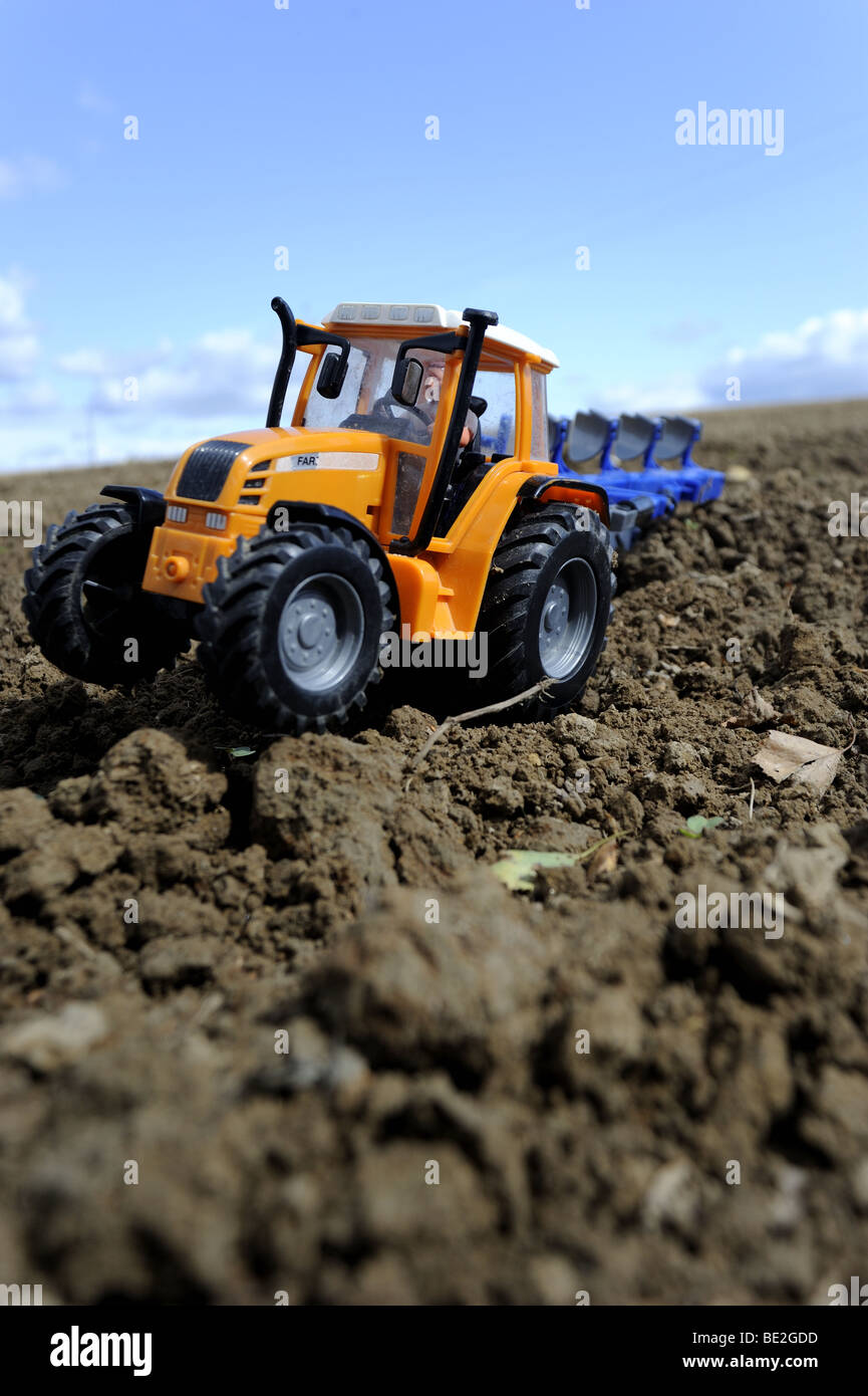 Plastic Toy Tractor on field Stock Photo - Alamy