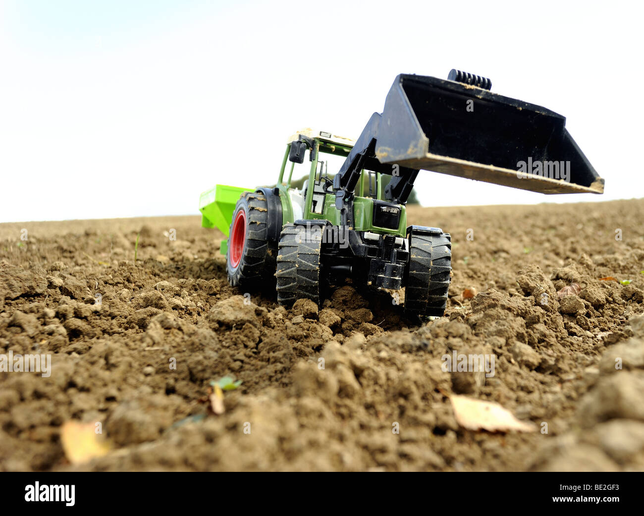 Plastic Toy Tractor on field Stock Photo - Alamy
