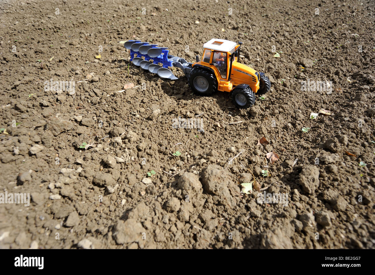 Plastic Toy Tractor on field Stock Photo - Alamy