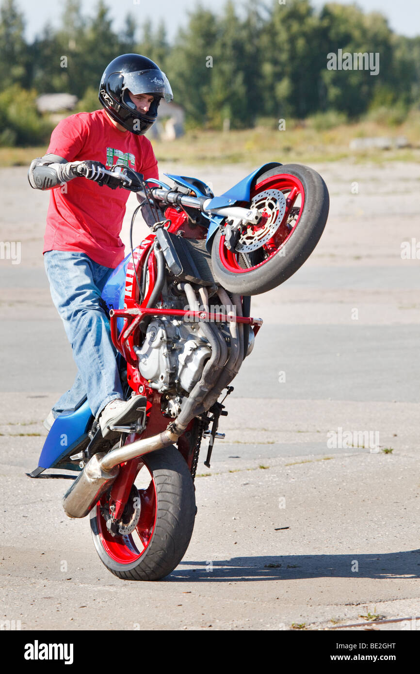 Stunt rider making wheelie Stock Photo - Alamy