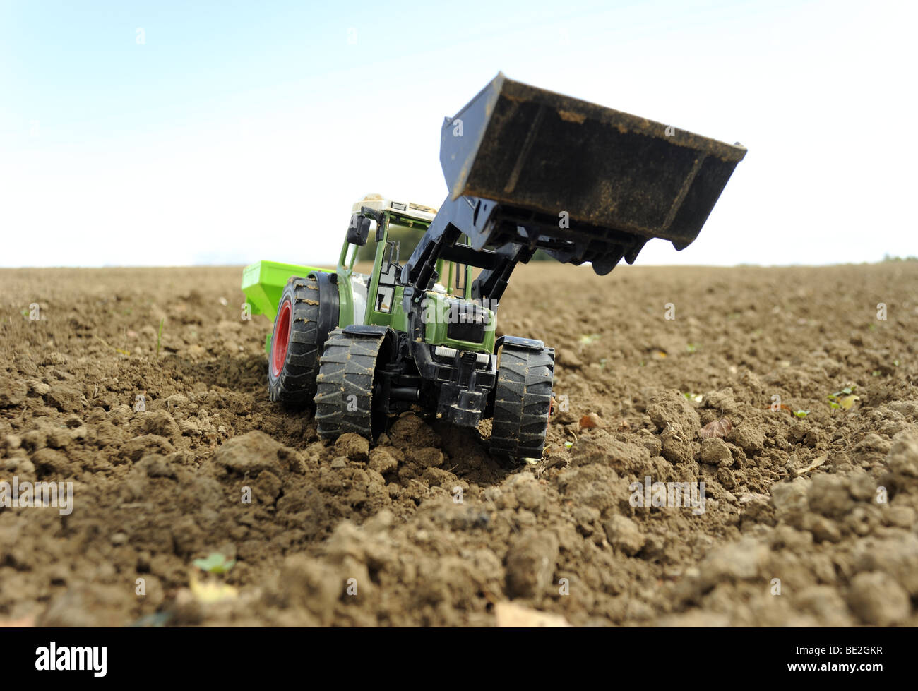Plastic Toy Tractor on field Stock Photo - Alamy