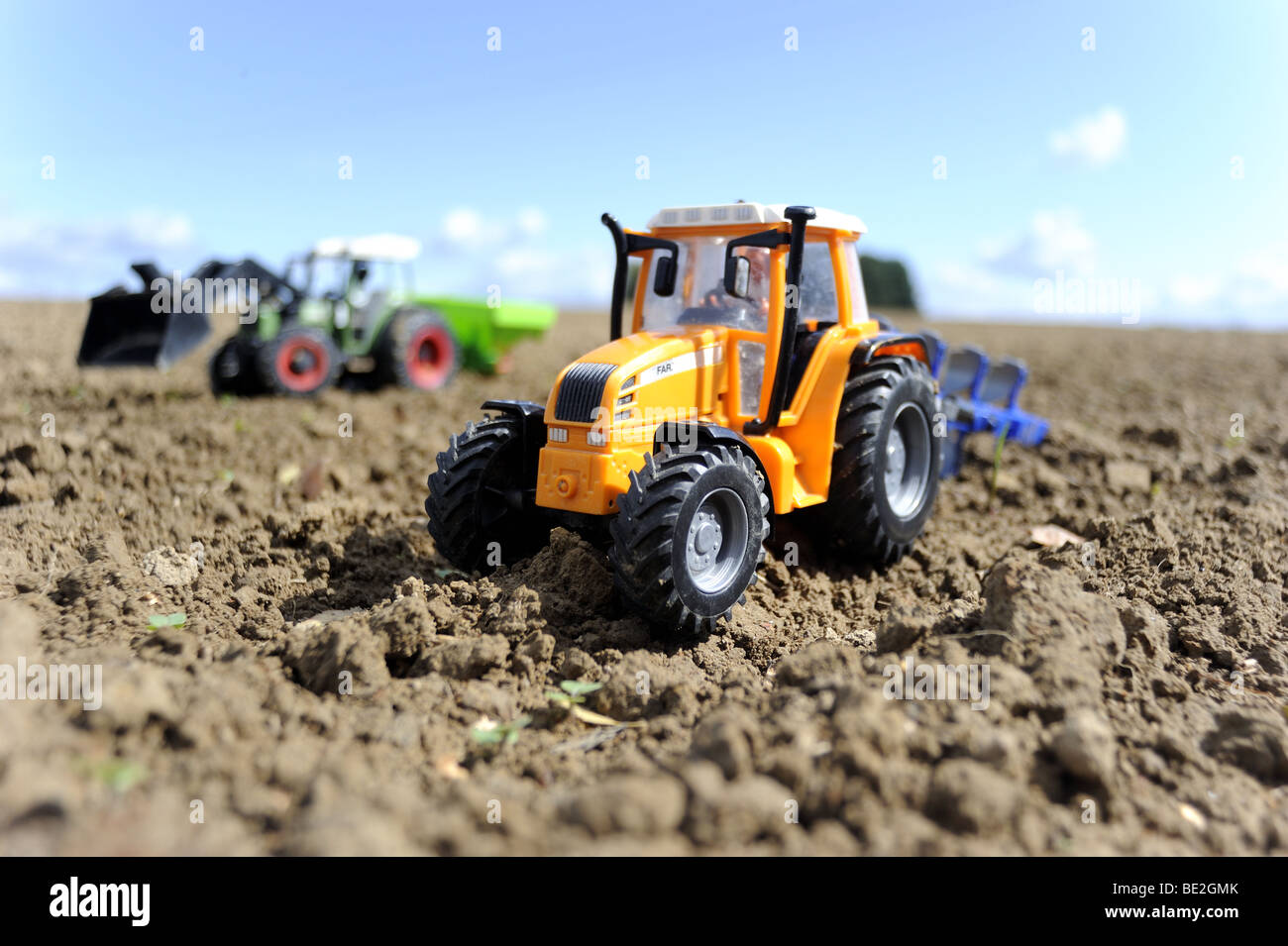 Plastic Toy Tractor on field Stock Photo - Alamy