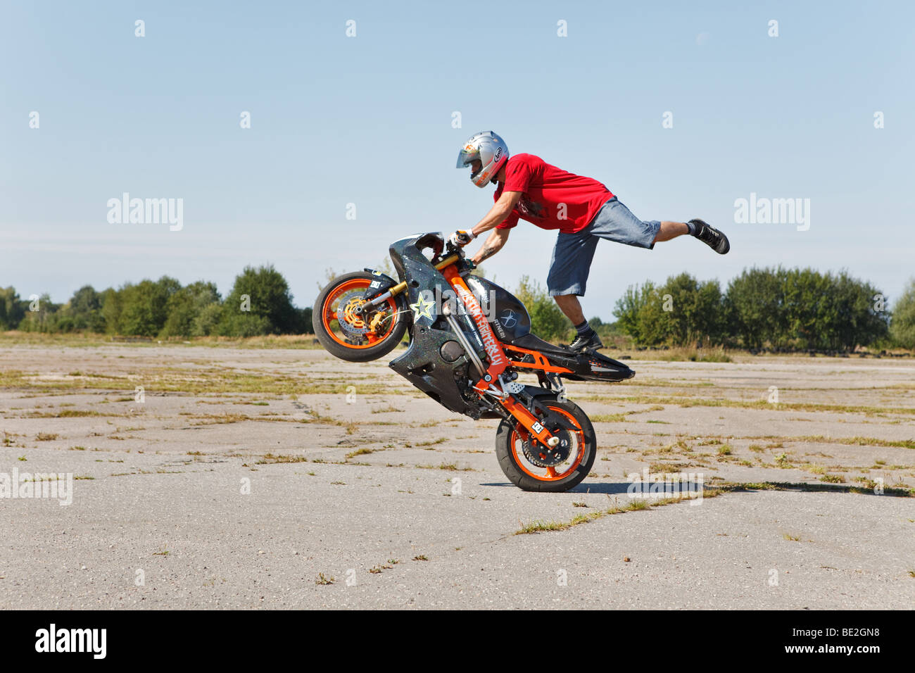 Stunt rider making wheelie Stock Photo - Alamy