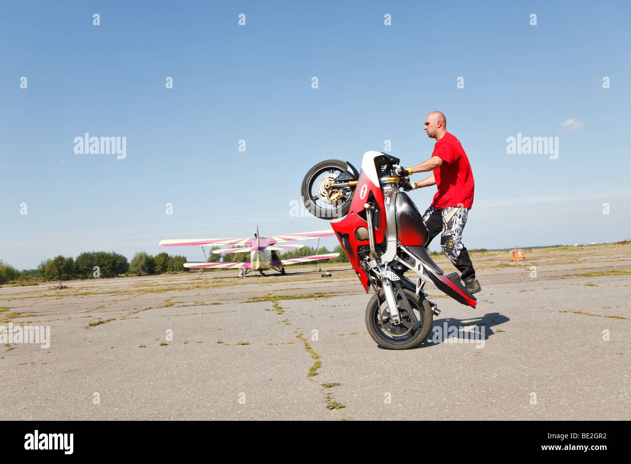 Stunt rider making wheelie Stock Photo - Alamy