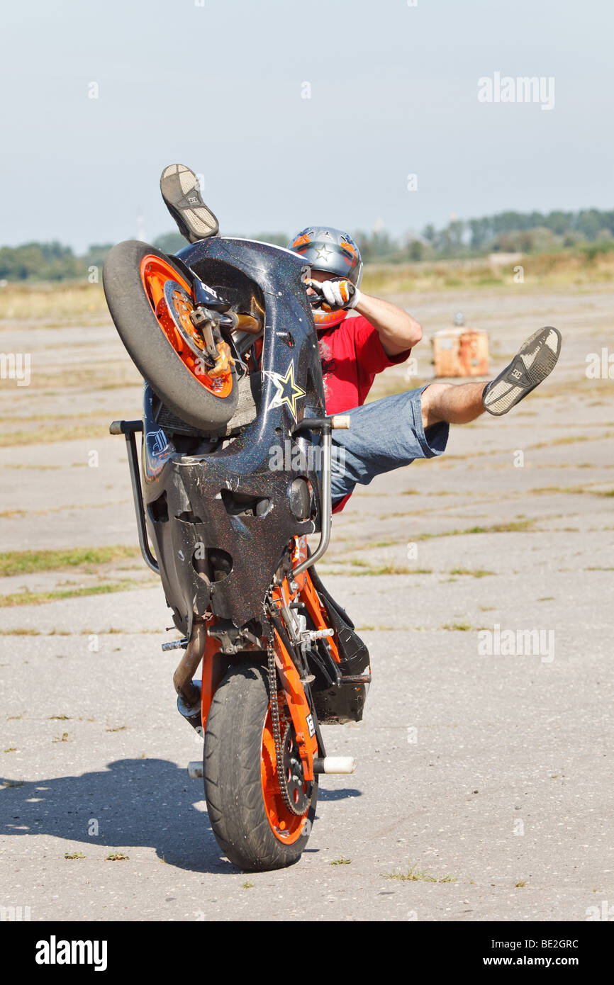 Stunt rider making wheelie Stock Photo - Alamy