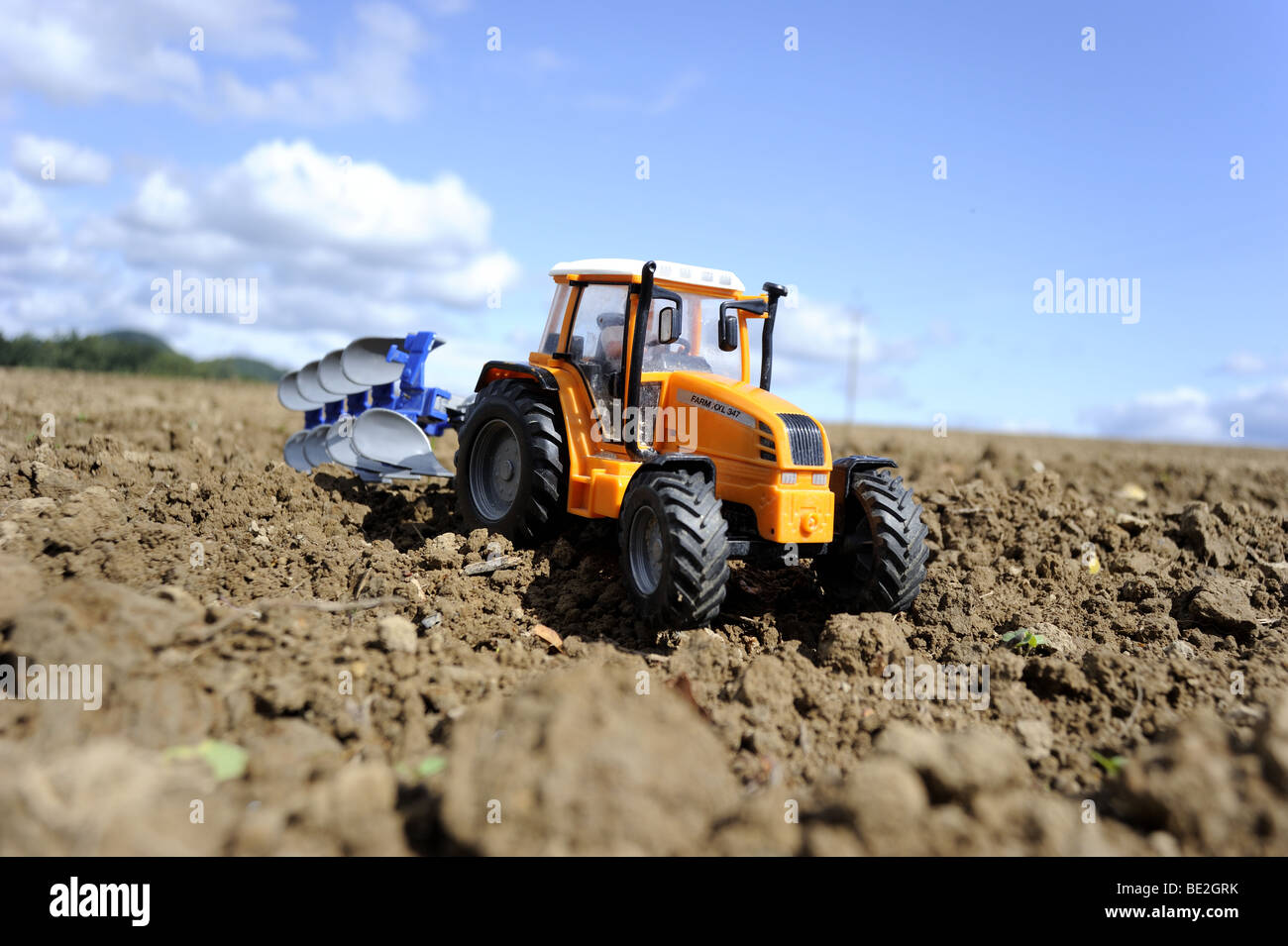Plastic Toy Tractor on field Stock Photo - Alamy
