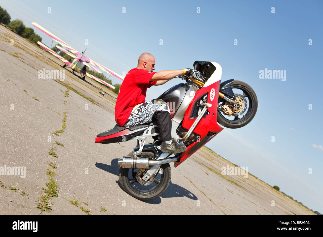 Stunt rider making wheelie Stock Photo - Alamy