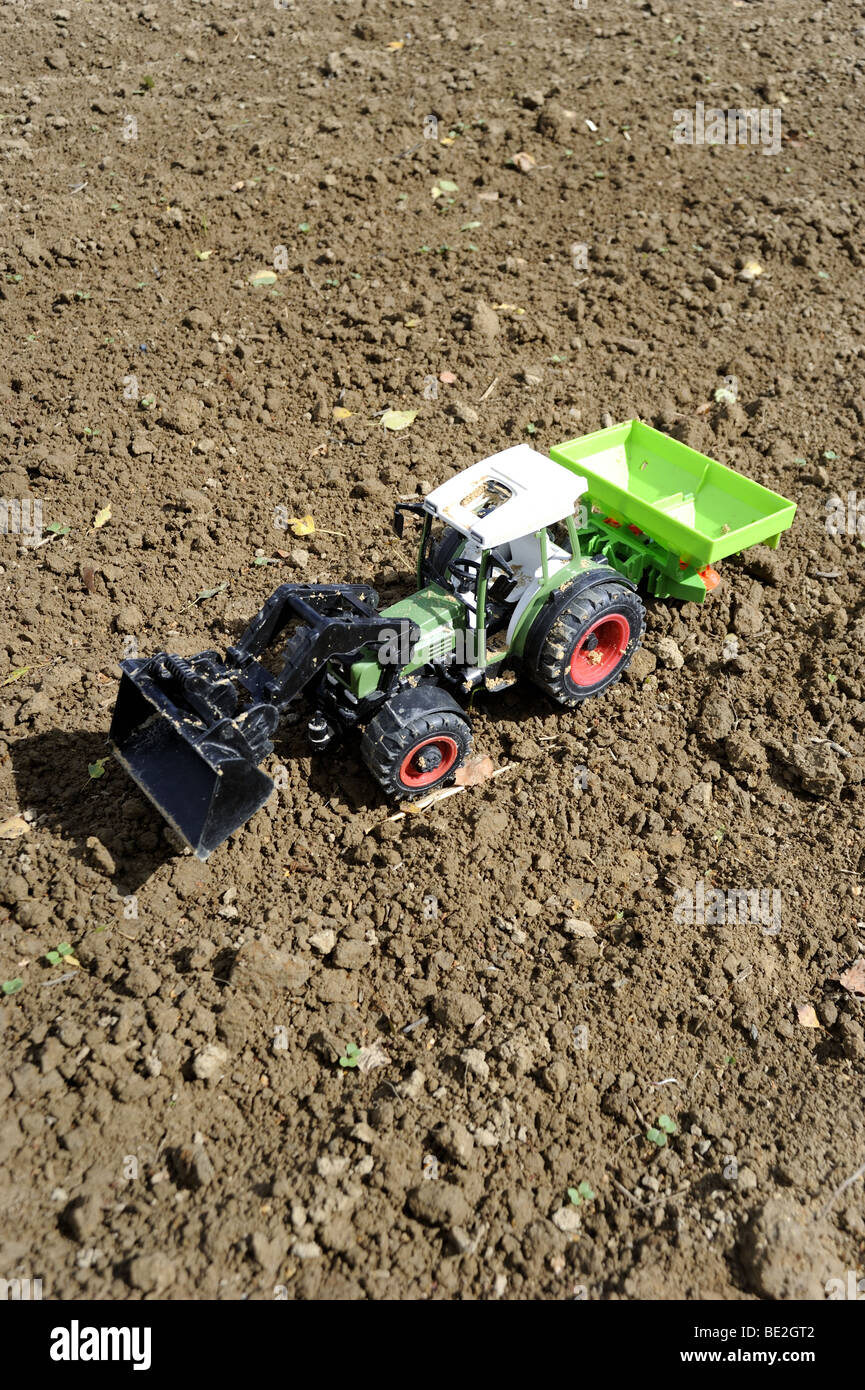 Plastic Toy Tractor on field Stock Photo - Alamy