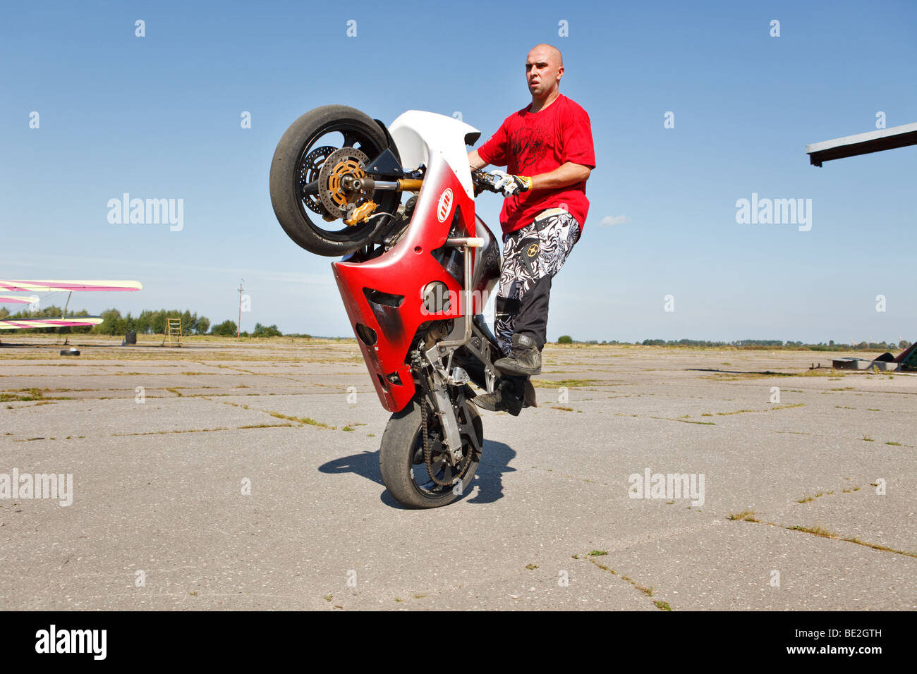 Stunt rider making wheelie Stock Photo - Alamy