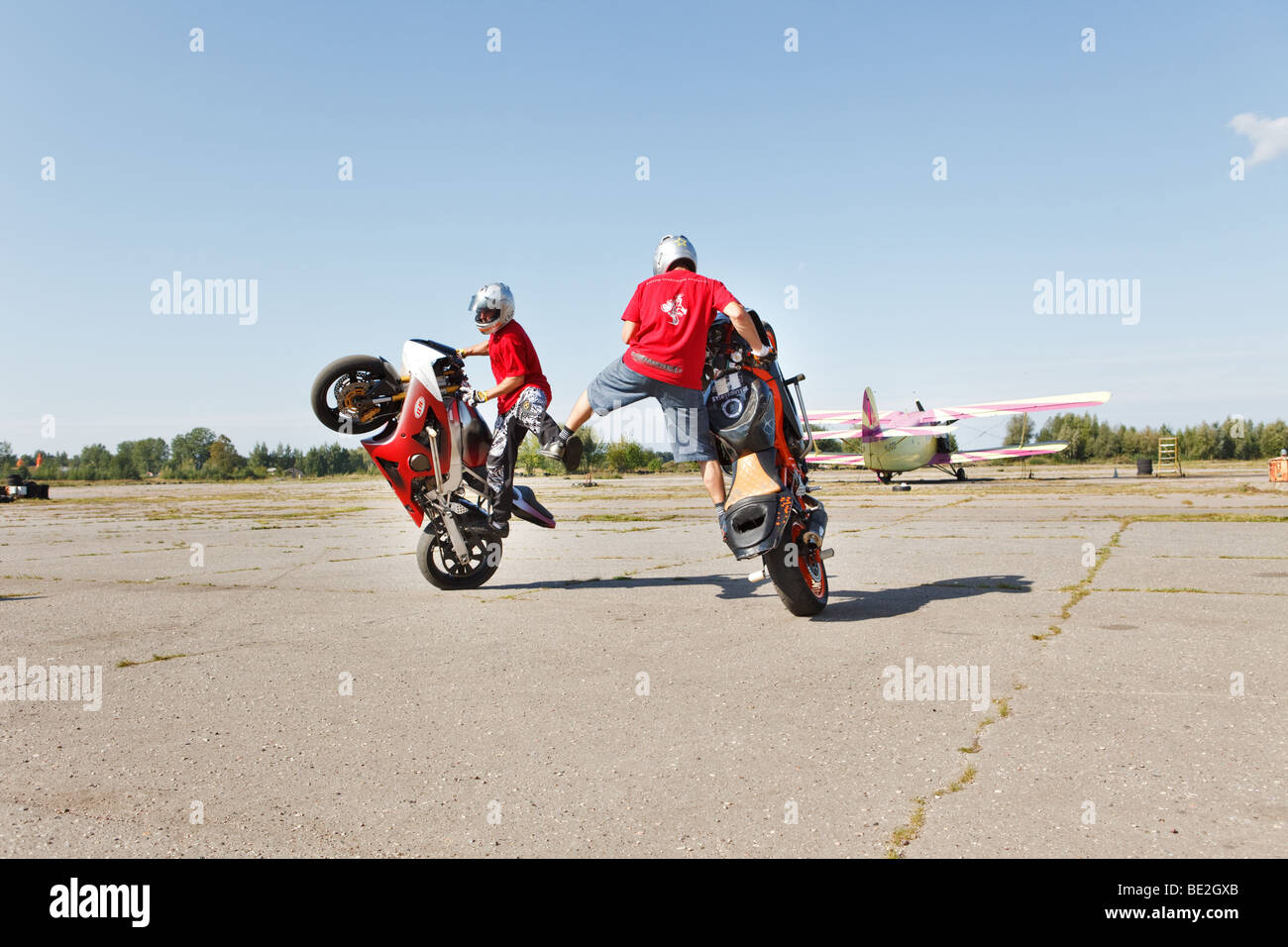 Two stunt riders making wheelie Stock Photo - Alamy