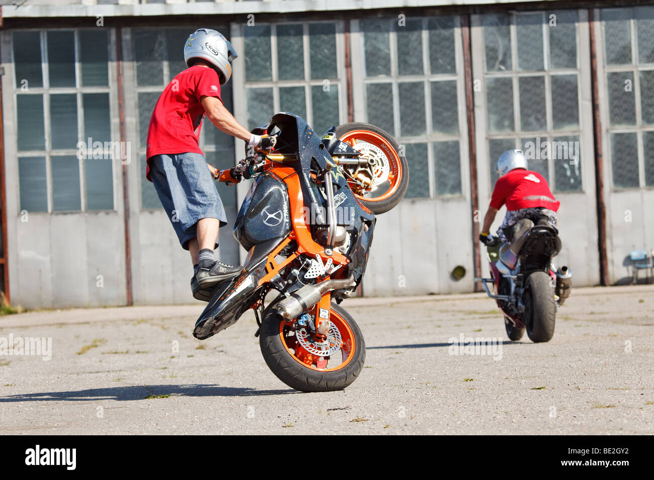 Stunt rider making wheelie Stock Photo - Alamy