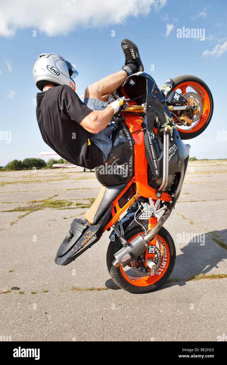 Stunt rider making wheelie Stock Photo - Alamy