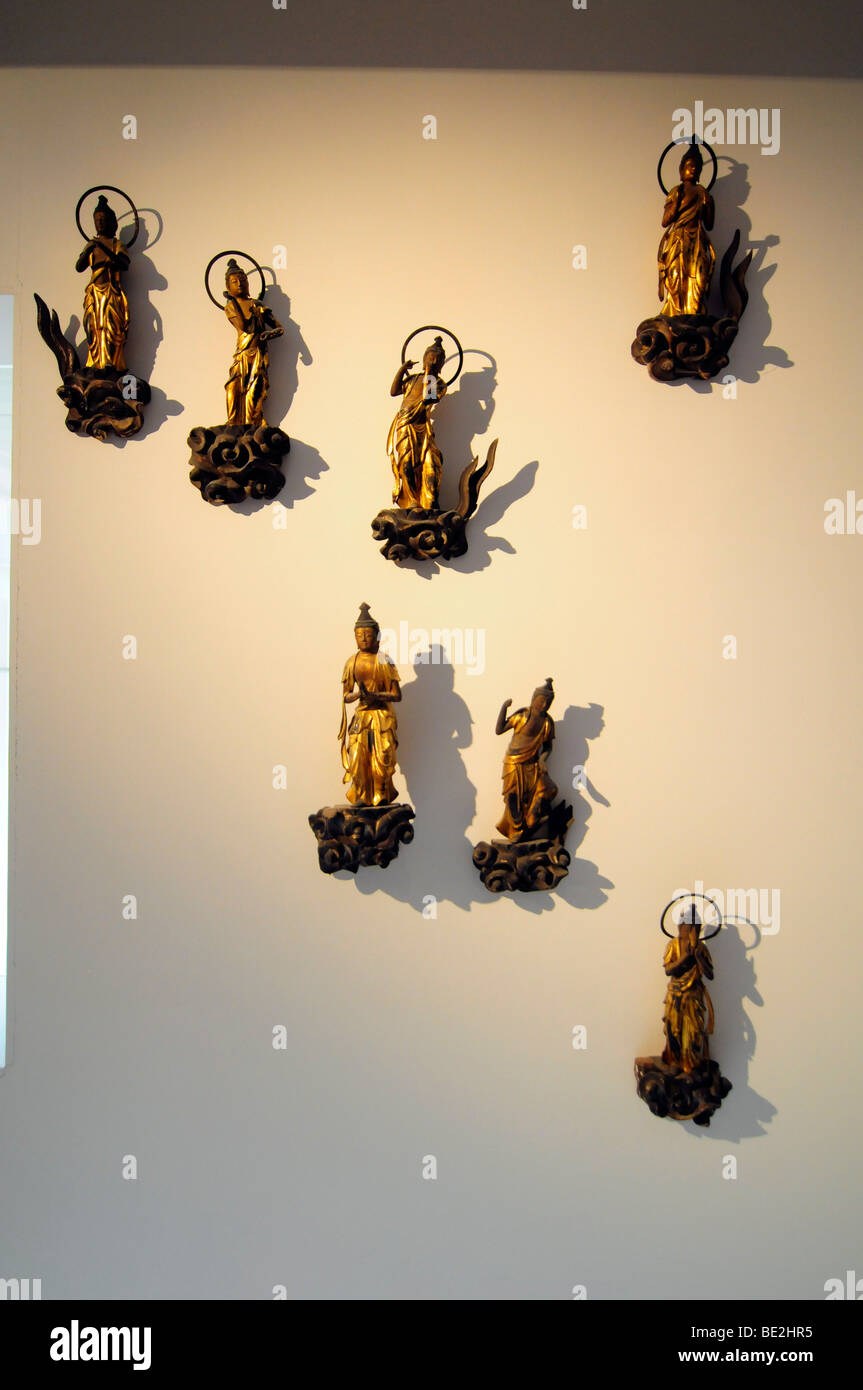 Seven little Asian statues on display inside the Musee Guimet, the ...