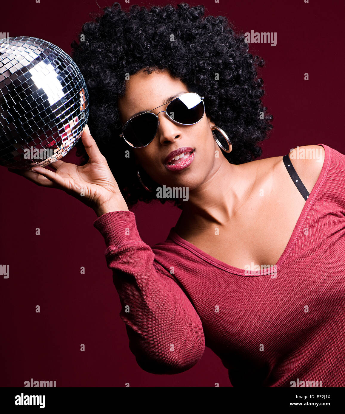 70s disco girl with a disco ball and a big afro hair Stock Photo - Alamy