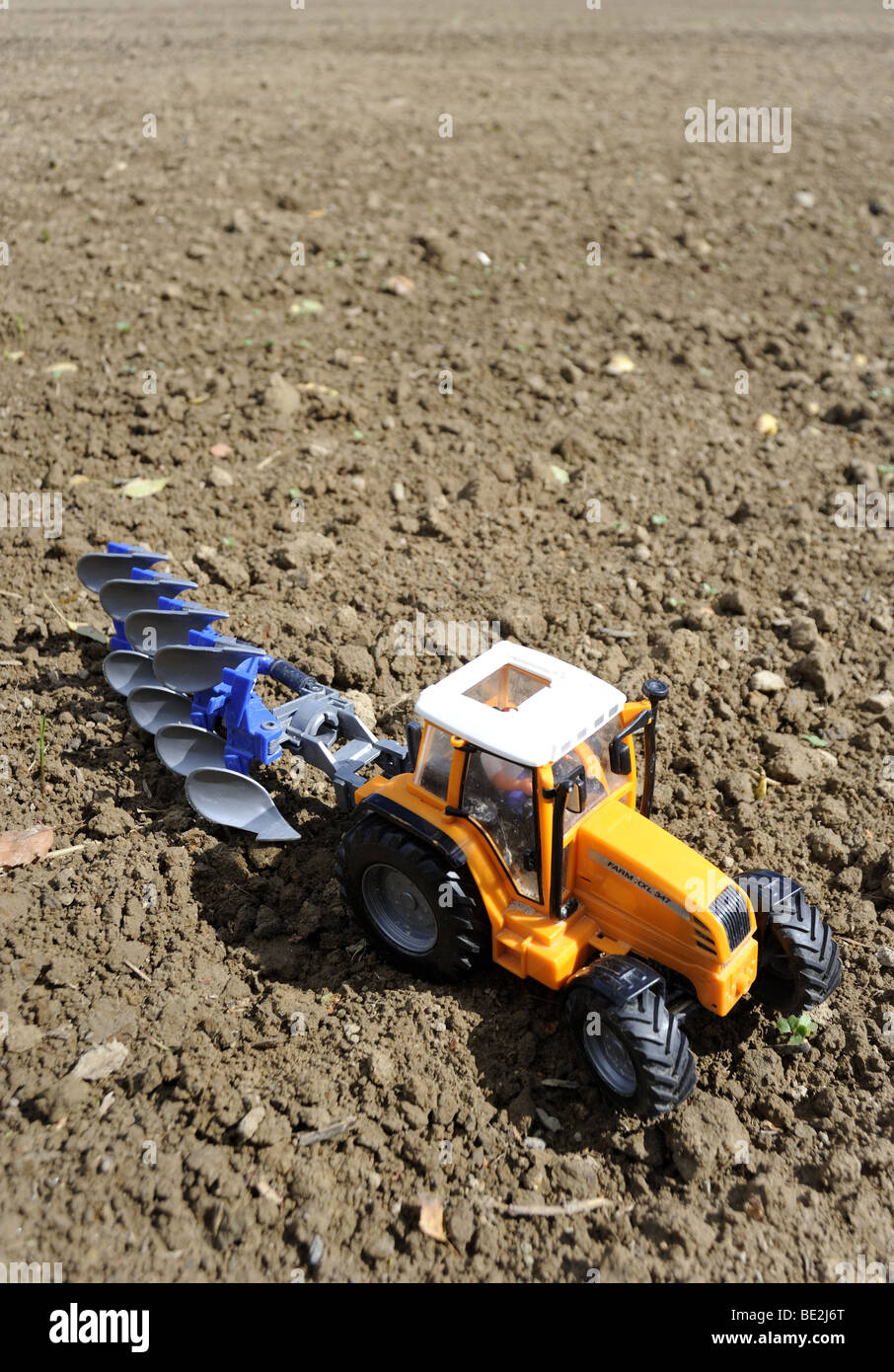 Plastic Toy Tractor on field Stock Photo - Alamy