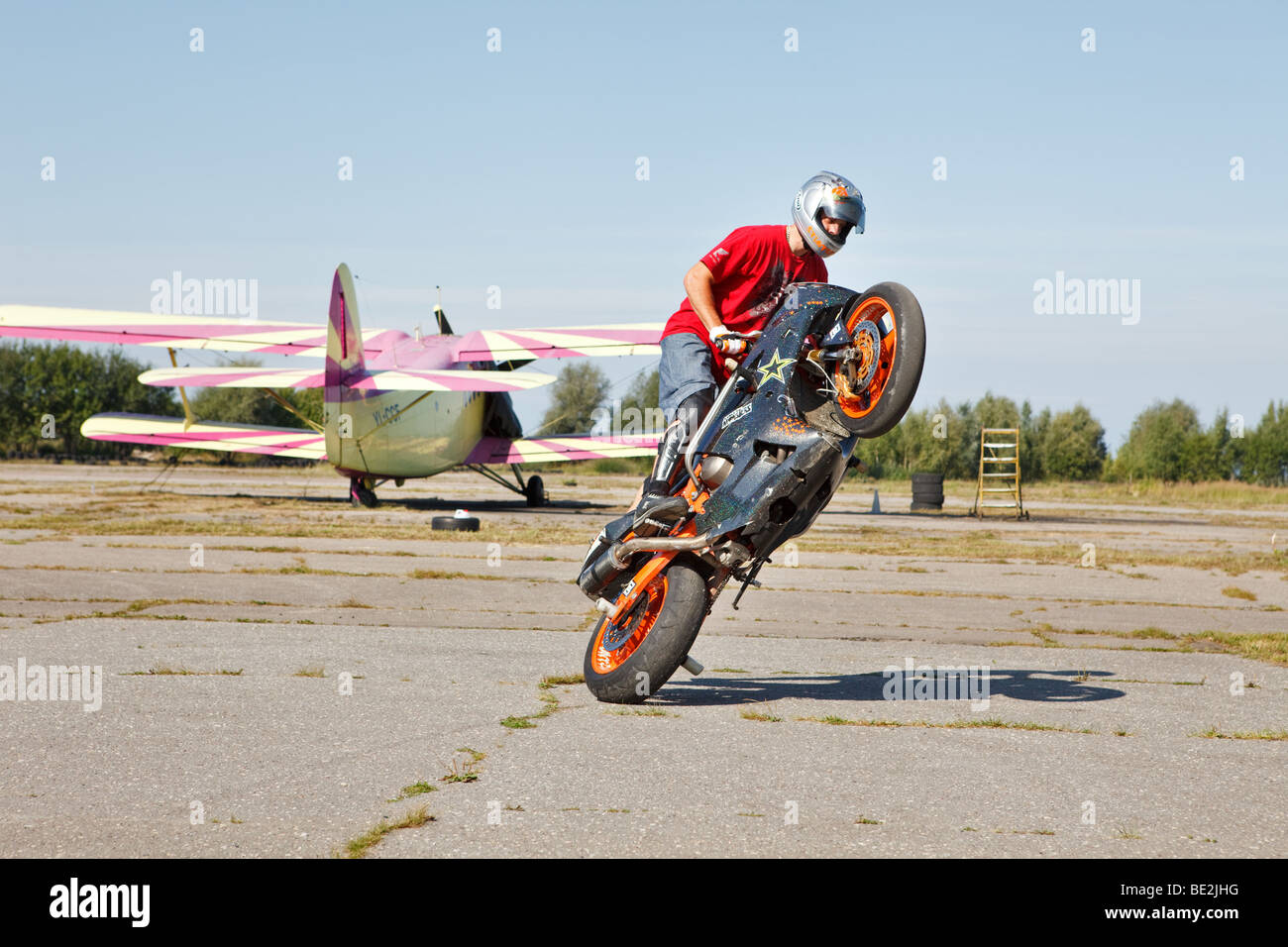 Stunt rider making wheelie Stock Photo - Alamy