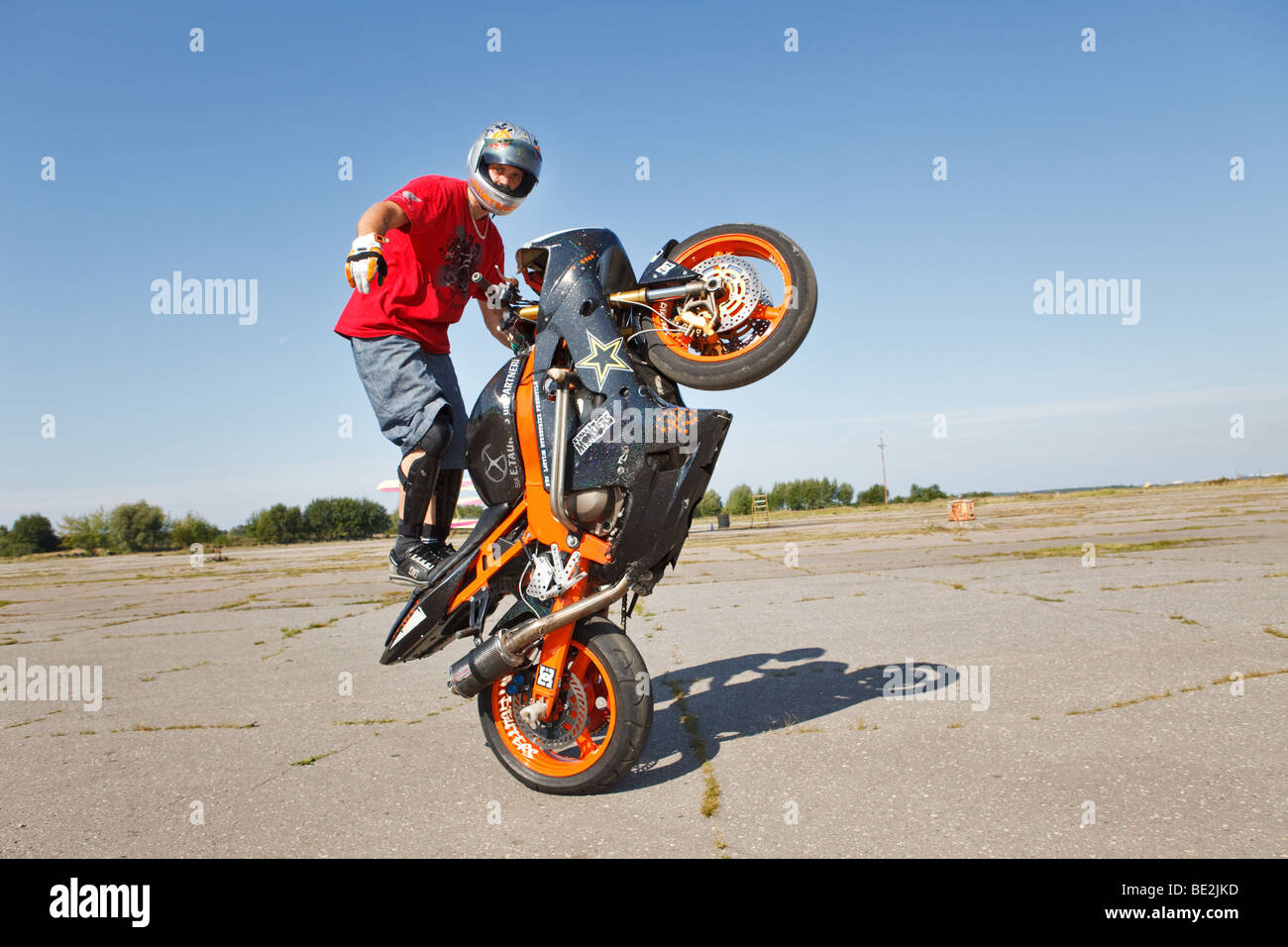 Stunt rider making wheelie Stock Photo - Alamy