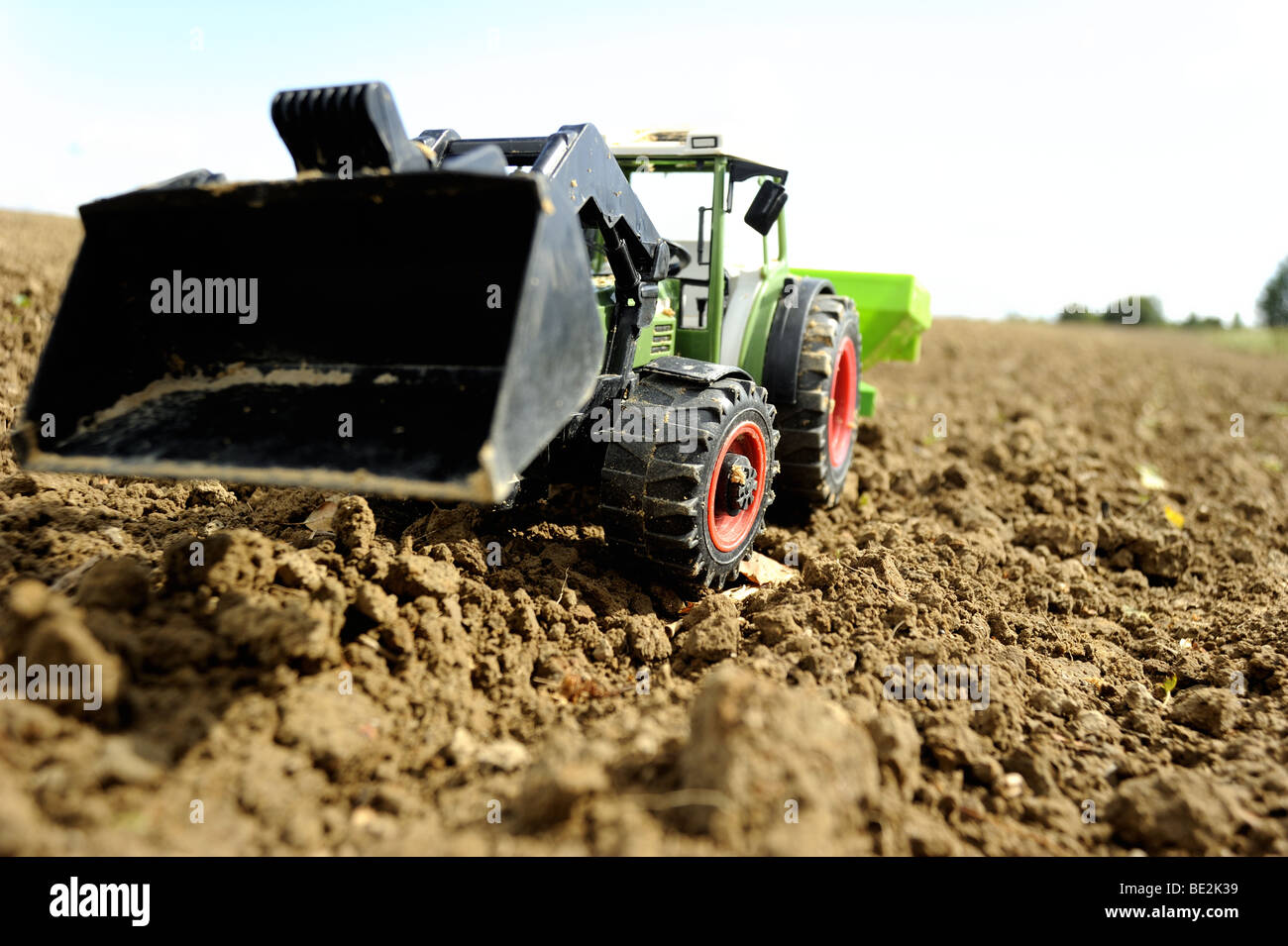 Plastic Toy Tractor on field Stock Photo - Alamy
