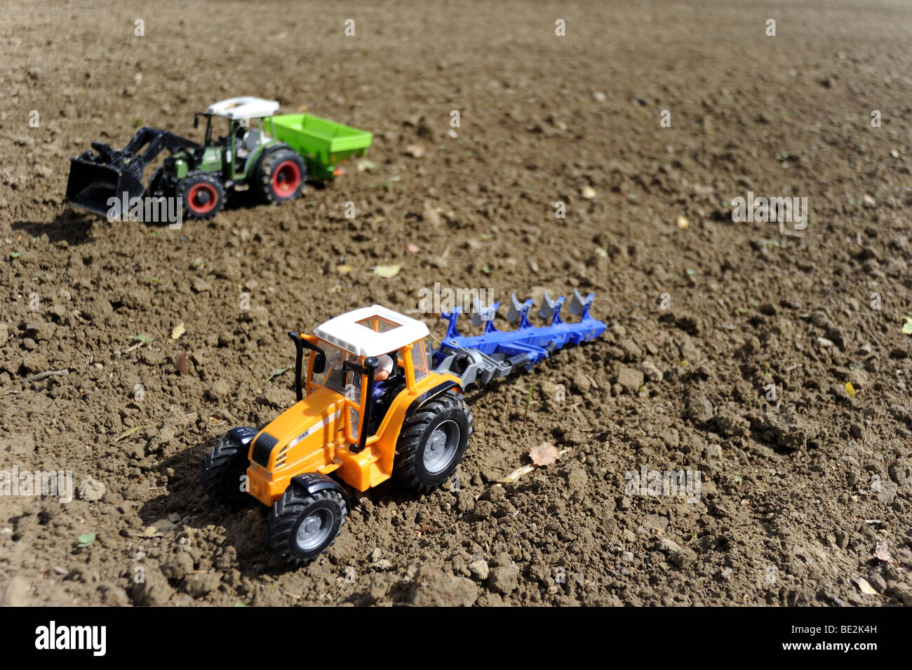 Plastic Toy Tractor on field Stock Photo - Alamy
