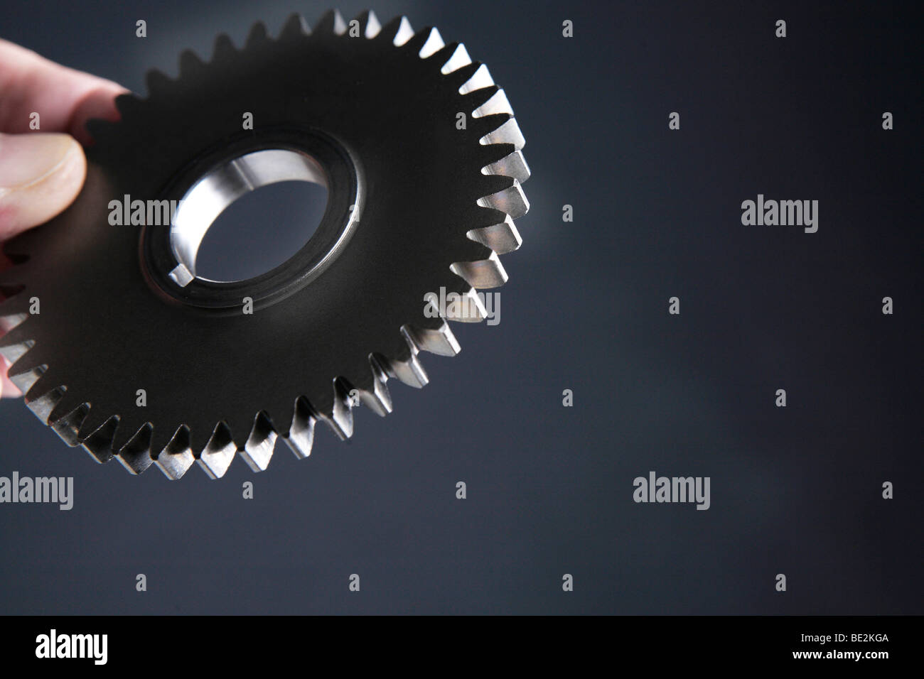 Hand with gear Stock Photo - Alamy