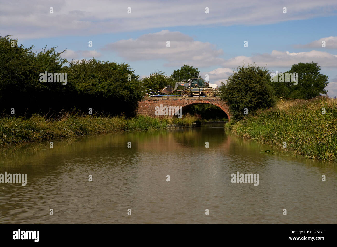 Tractor crossing a canal bridge, Grand Union Canal, Northamptonshire ...