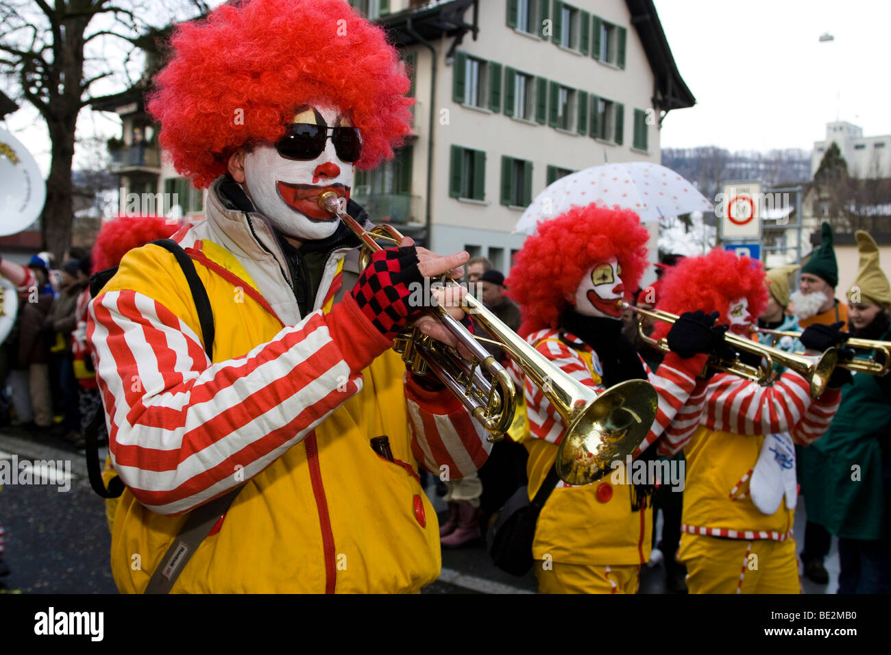 Clown playing the trumpet at the carnival parade in Malters, Lucerne ...
