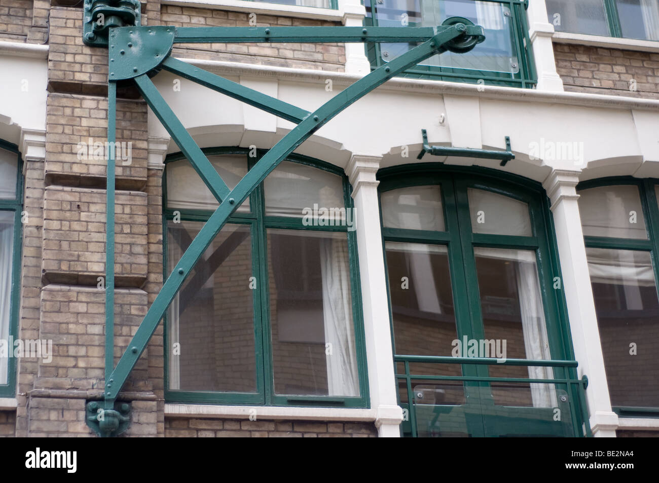 Old lifting arm and pulley on a building in London Stock Photo - Alamy