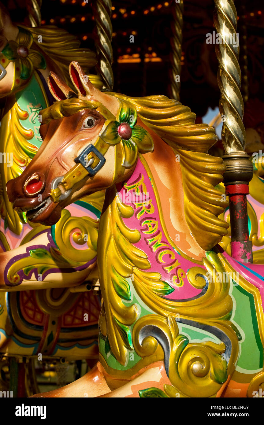 Ornately carved horses on a traditional carousel at a funfair at the ...