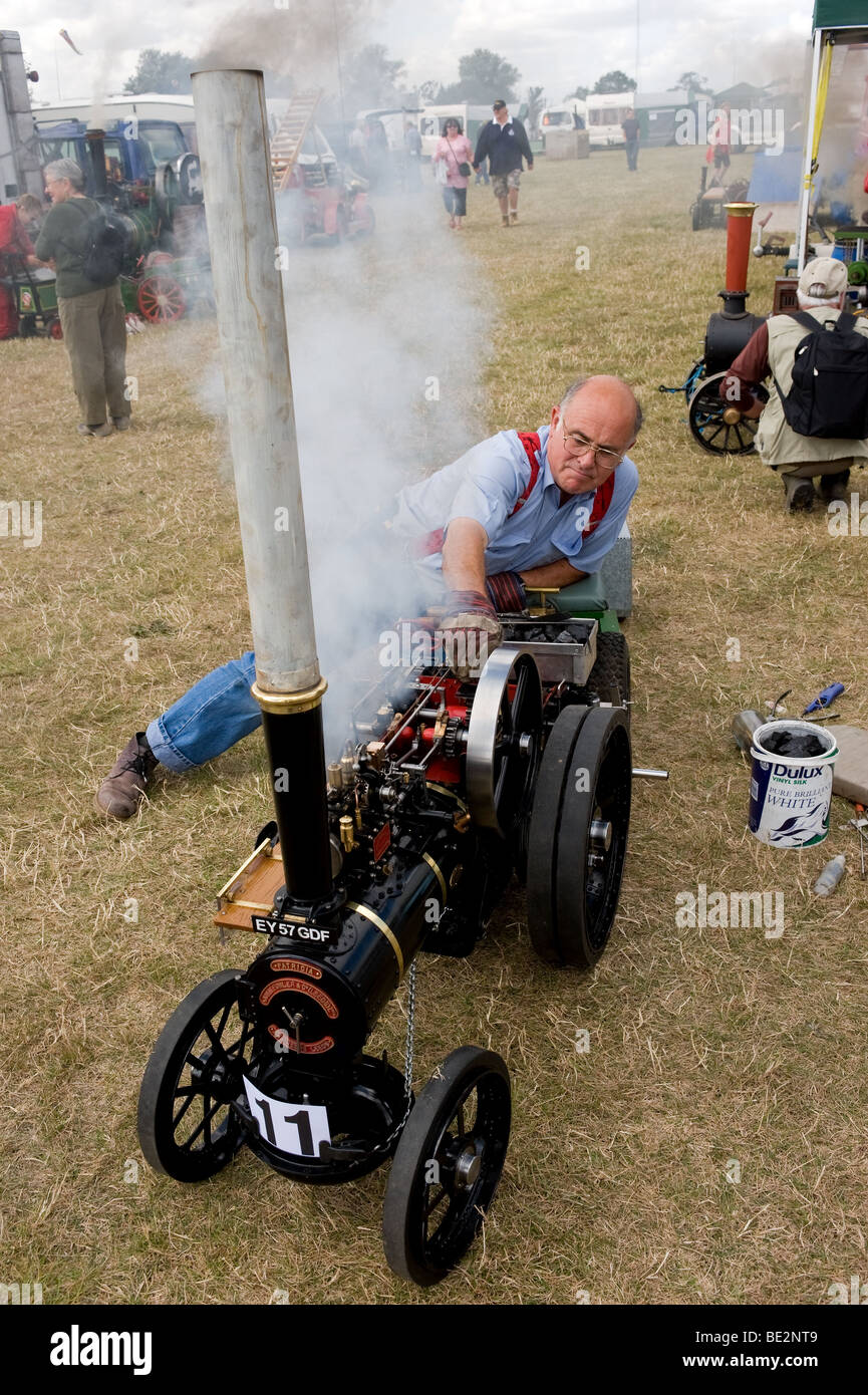 A man carrying out maintenance on his miniature steam engine at the ...