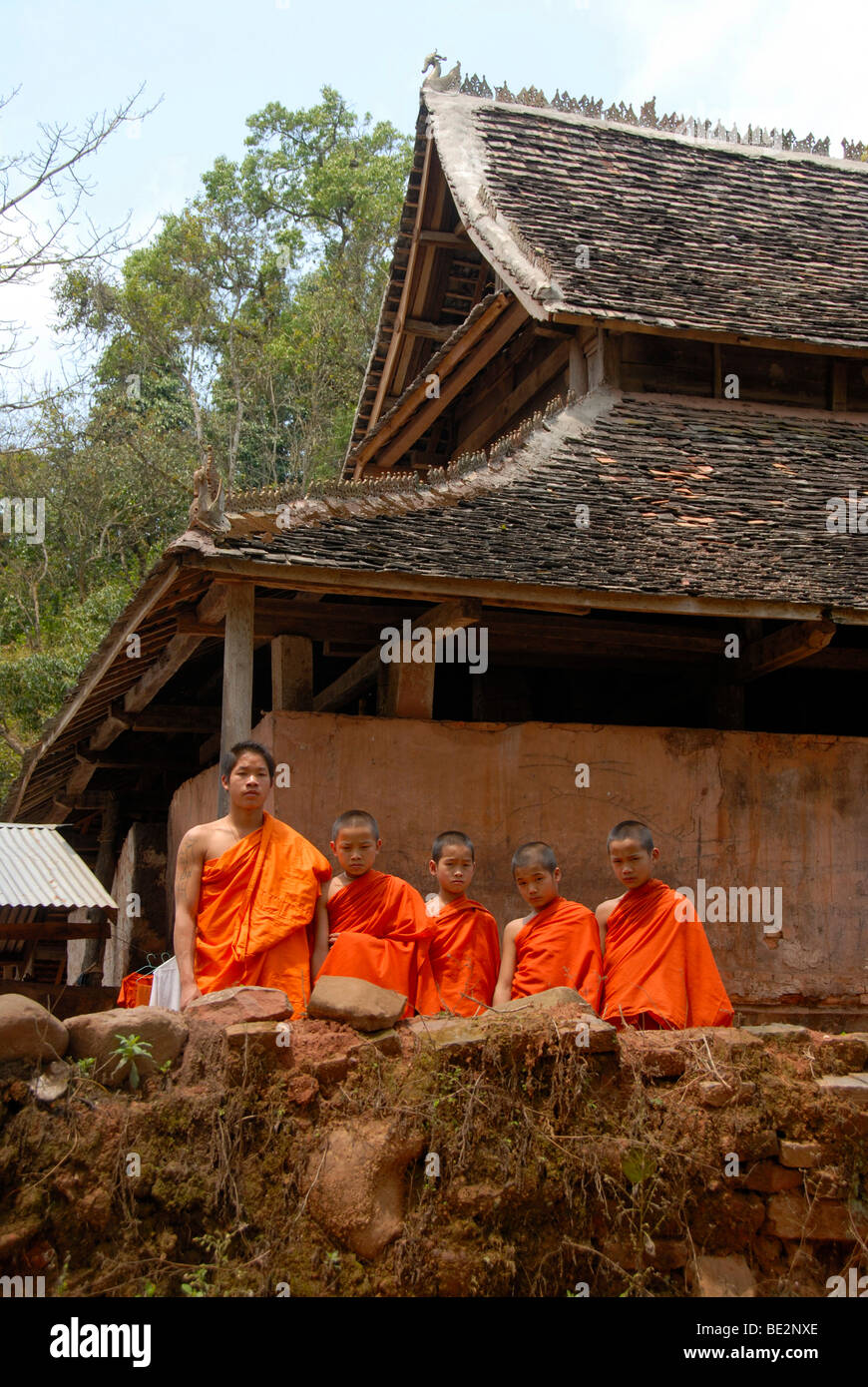 Theravada Buddhism, monk with novices dressed in orange cowls, Tai Lue ...