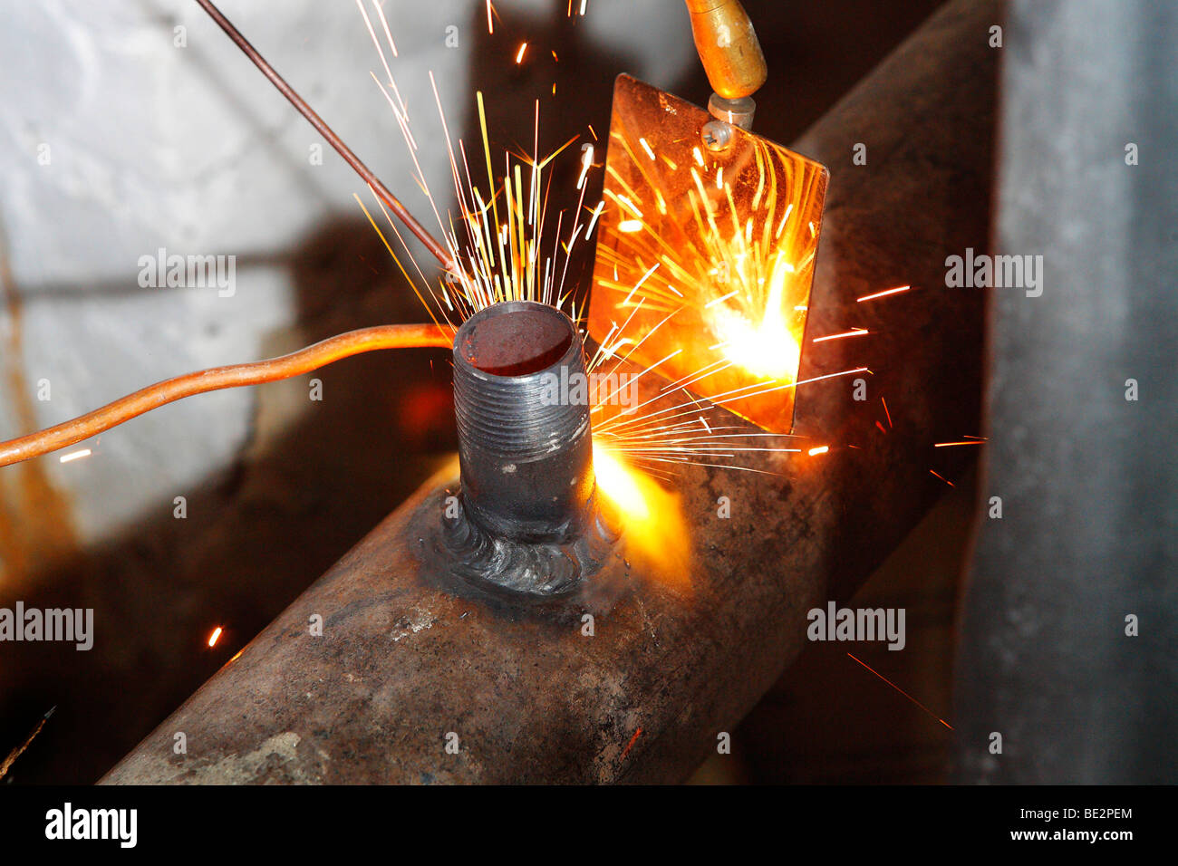 Welding with a mirror Stock Photo - Alamy