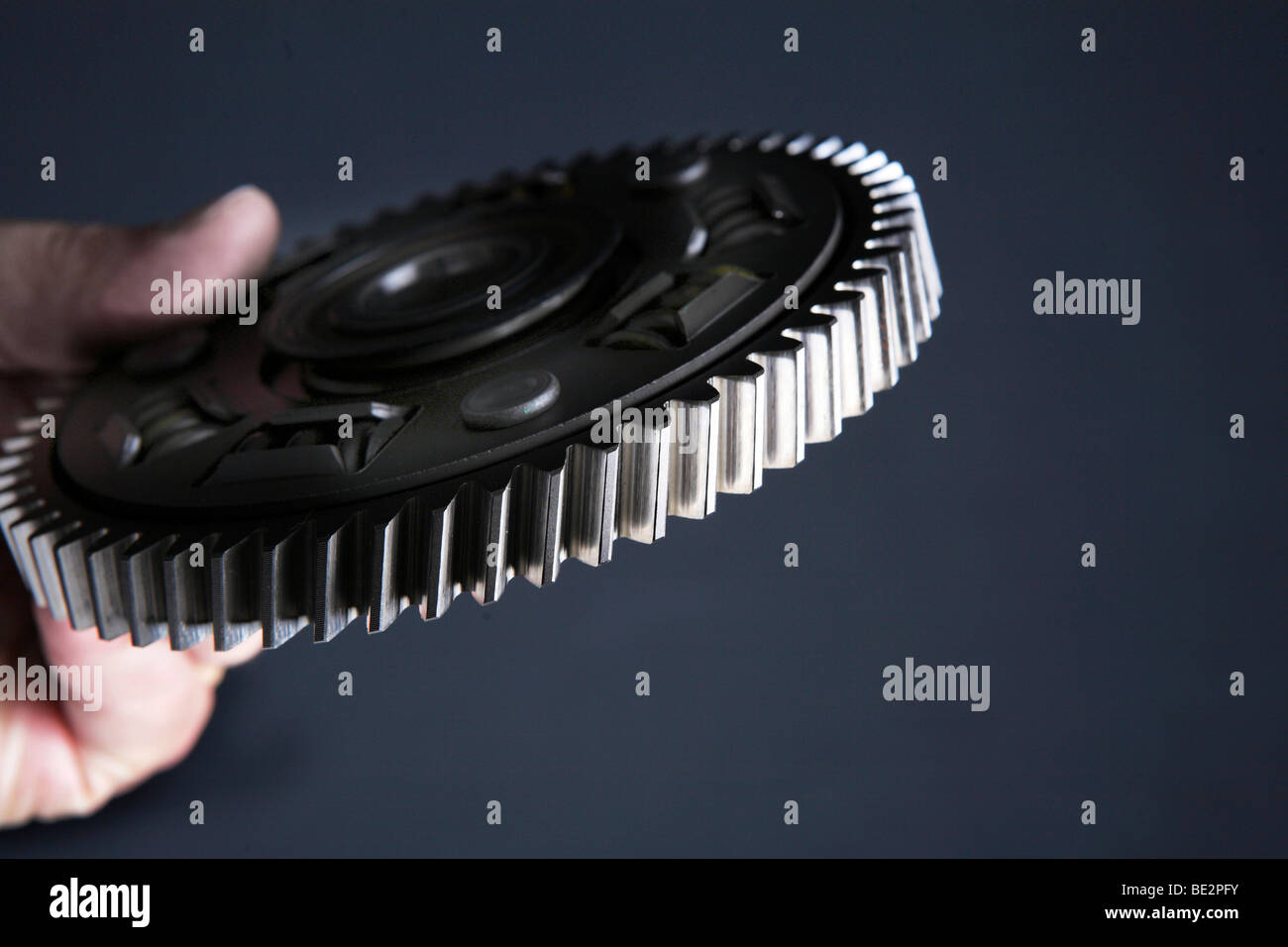 Hand with gear Stock Photo - Alamy