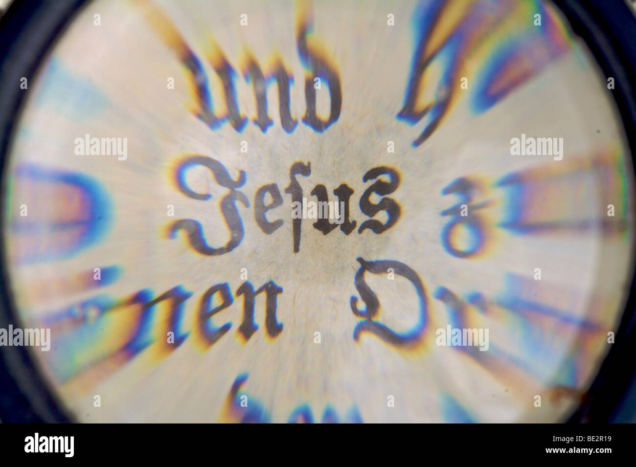 The Word "Jesus" in an old Bible, seen through a magnifying glass Stock ...