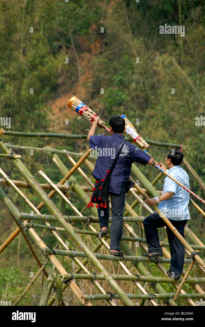 Men laying fireworks on a launching pad, Pi Mai, Lao New Year festival ...