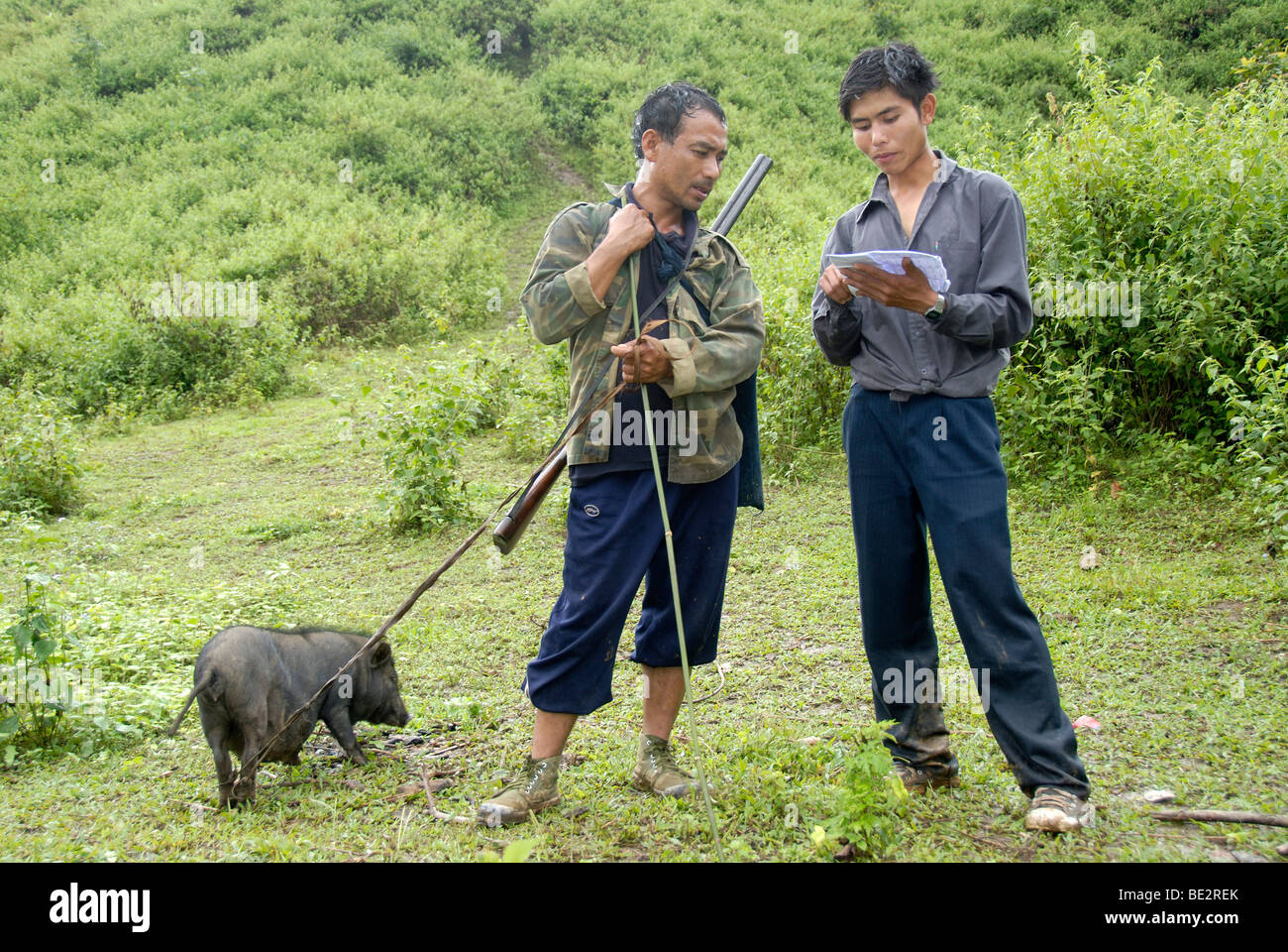 Laotians in conversation, the man Pixor Akha ethnic group with pork and ...
