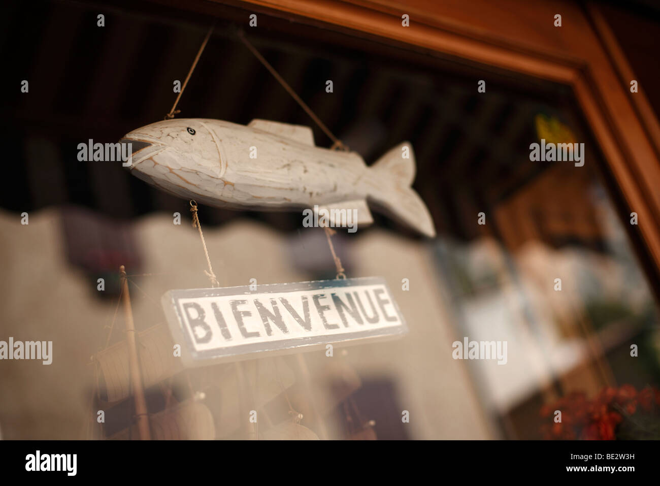 A welcome or bienvenue sign in the door of a fish restaurant in France ...