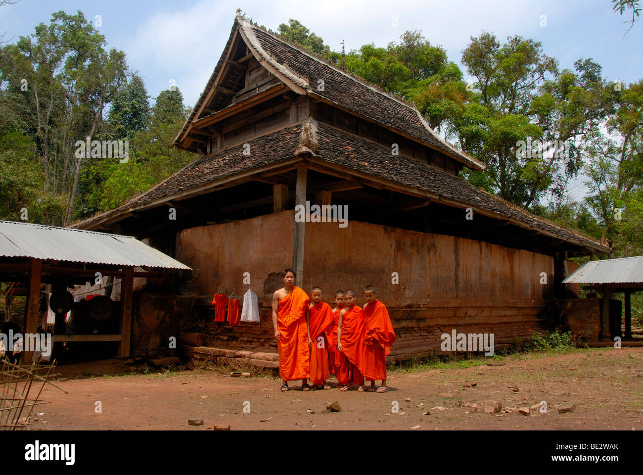 Theravada Buddhism, monk with novices dressed in orange cowls, Tai Lue ...