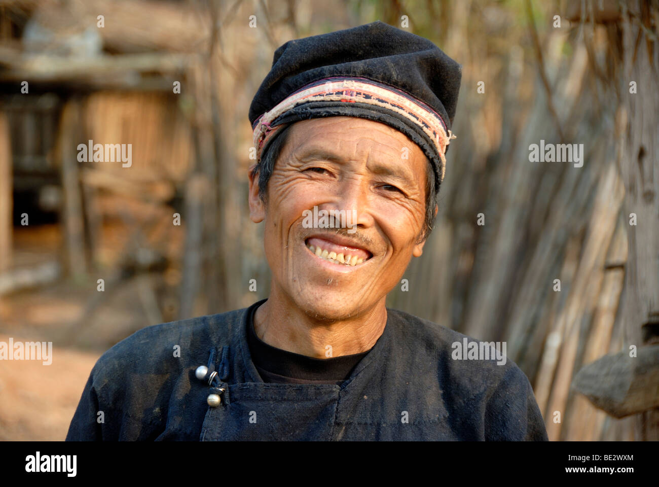 Poverty, portrait, ethnology, Yao man smiling and wearing a traditional ...