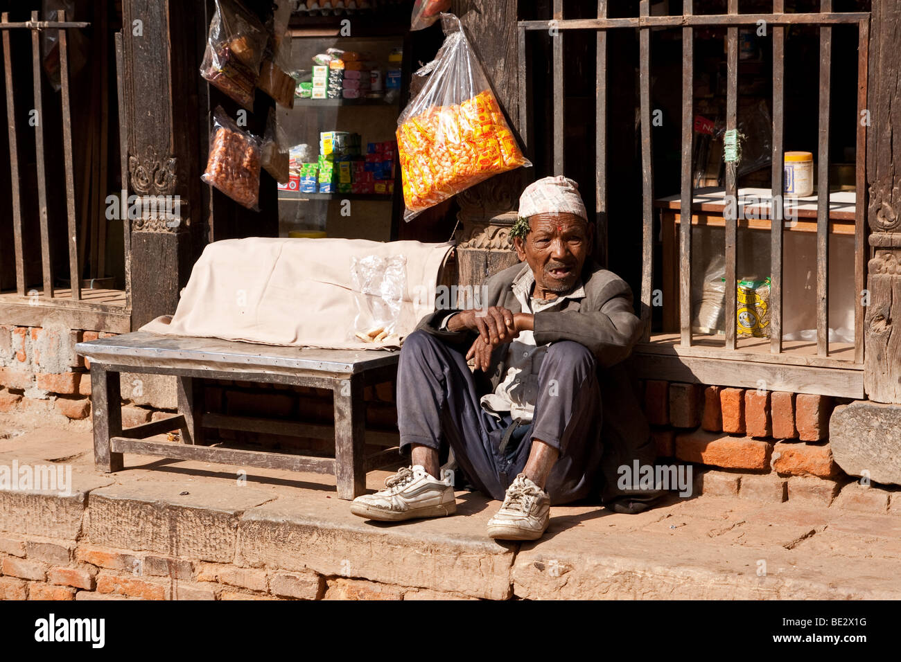 Nepali guy having a moment outside a small local stall Stock Photo - Alamy