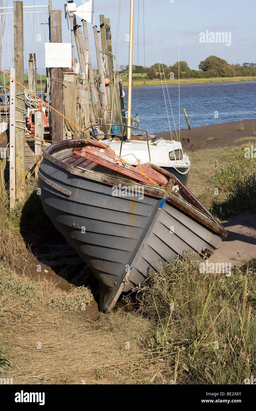 Open clinker built boat alongside jetty at Skippool Lancashire Stock ...
