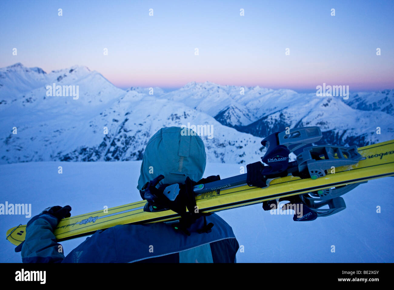 Ski touring, looking over the snowy mountain peaks shortly before ...