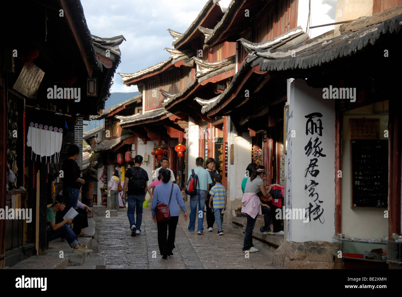 People, tourists, street in the old town with Chinese characters ...