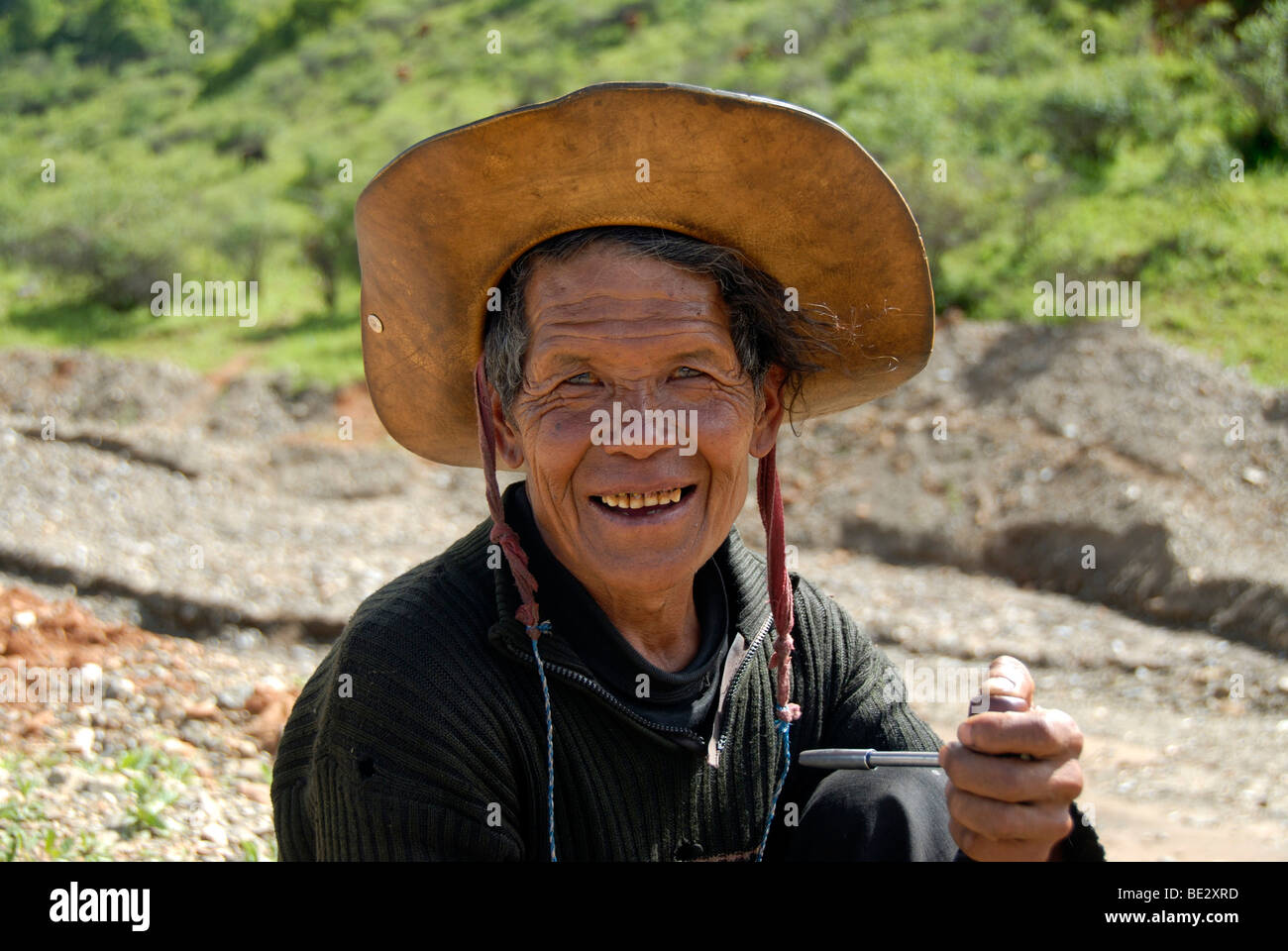 Portrait, ethnology, man of the Mosu ethnicity with hat, smiling and ...