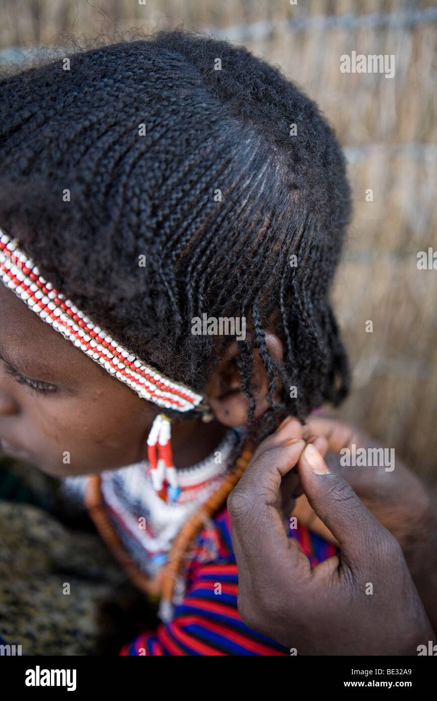 Girls are plaiting each other's hair. This ceremony takes at least 2 ...