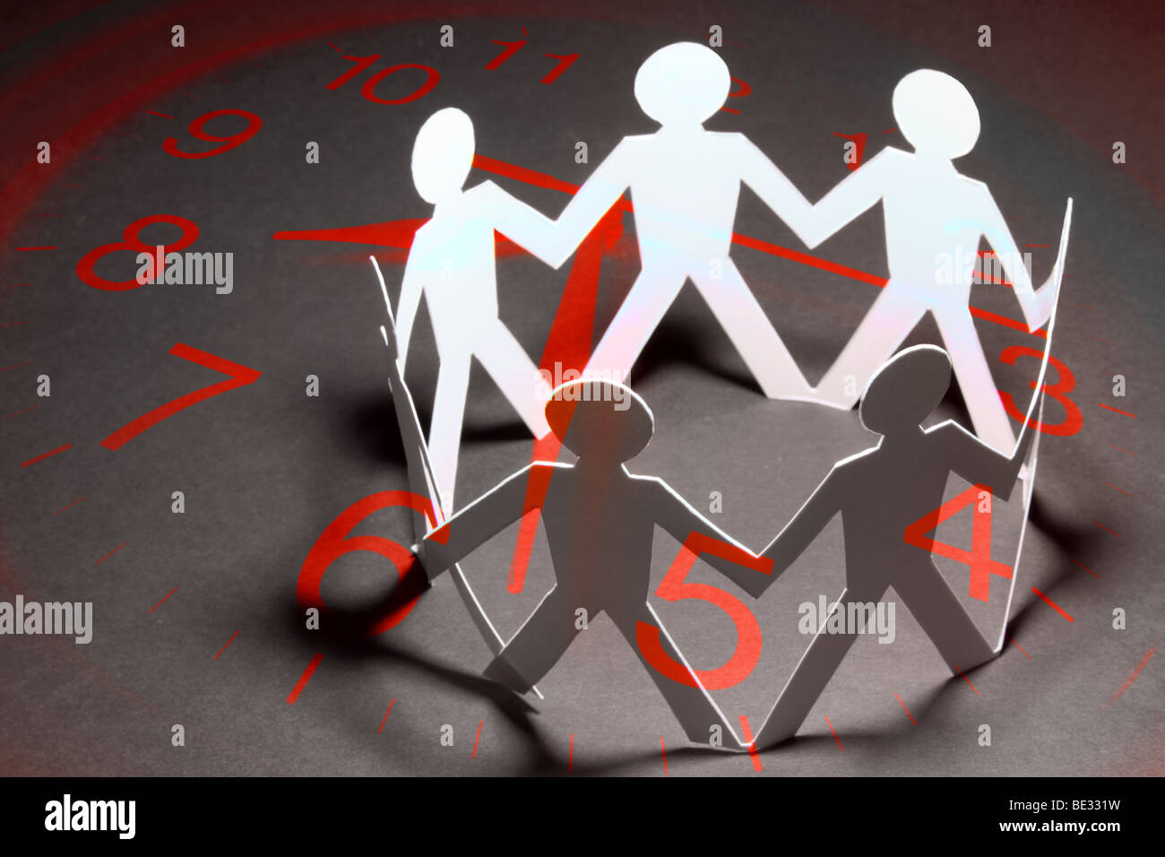 Paper Cutout Dolls and Clock Stock Photo - Alamy