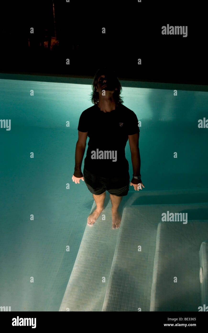 a strange eerie photo of dressed man standing up to his waist in ...