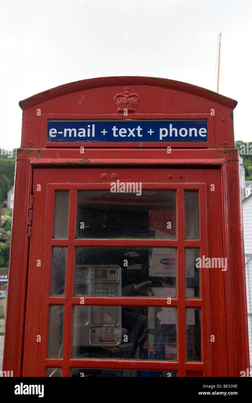 close up of old style british red phone box with the phrase 'e-mail+ ...